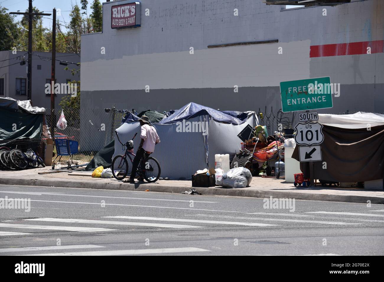 Los Angeles, CA USA - June 30, 2021: Homeless man on a bicycle along ...