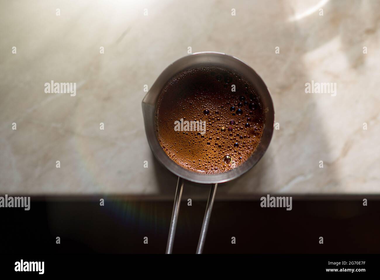 ready-made turkish coffee in a cezva in a turk on the table top view ...