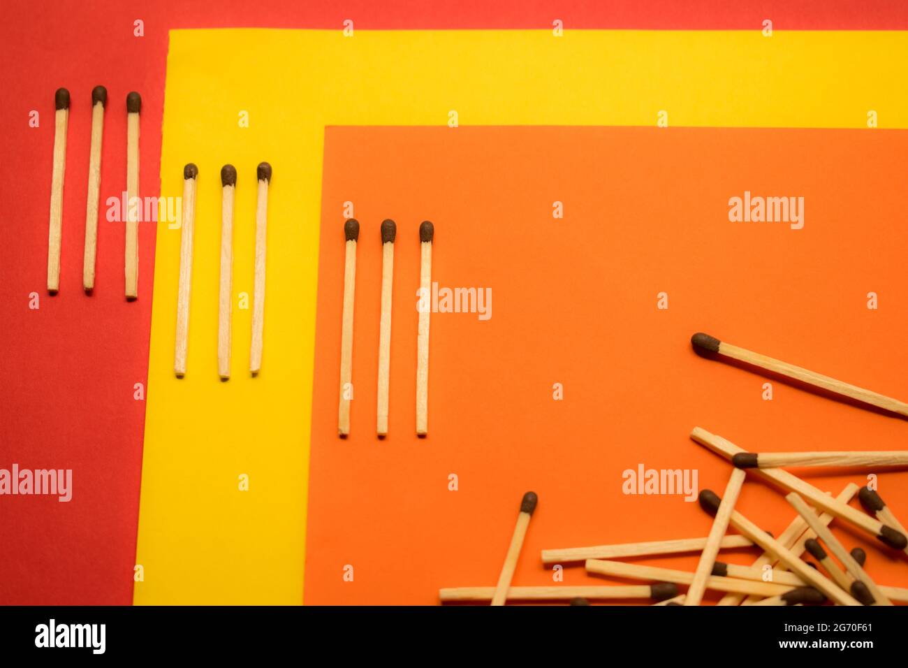 Some wooden matches on a clorful yellow, red and orange surface Stock ...