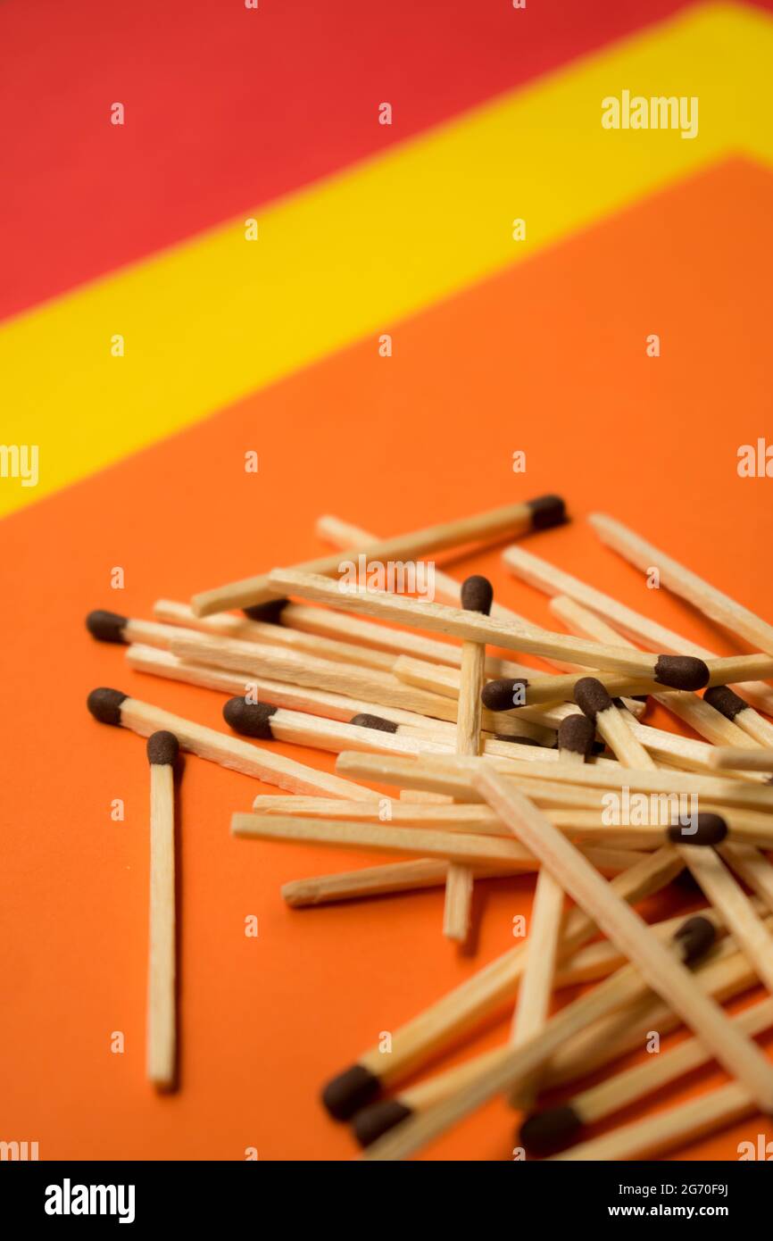 Some wooden matches on a clorful yellow, red and orange surface Stock ...