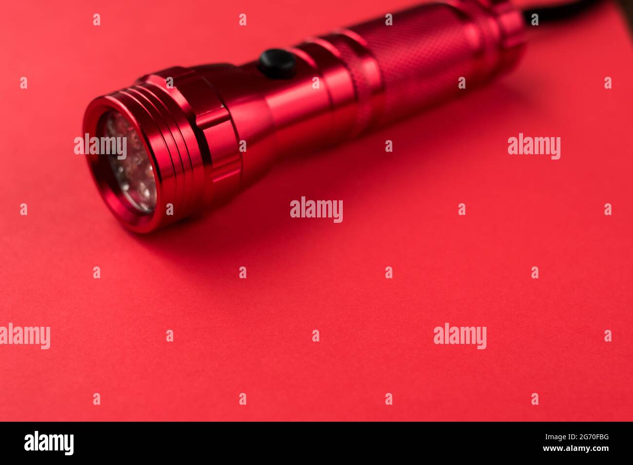Red bright flashlight on a red surface with copy space Stock Photo - Alamy