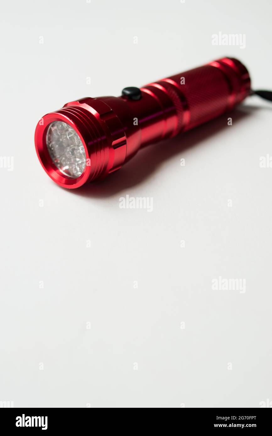 Red bright flashlight with led bulbs on a white background with copy ...