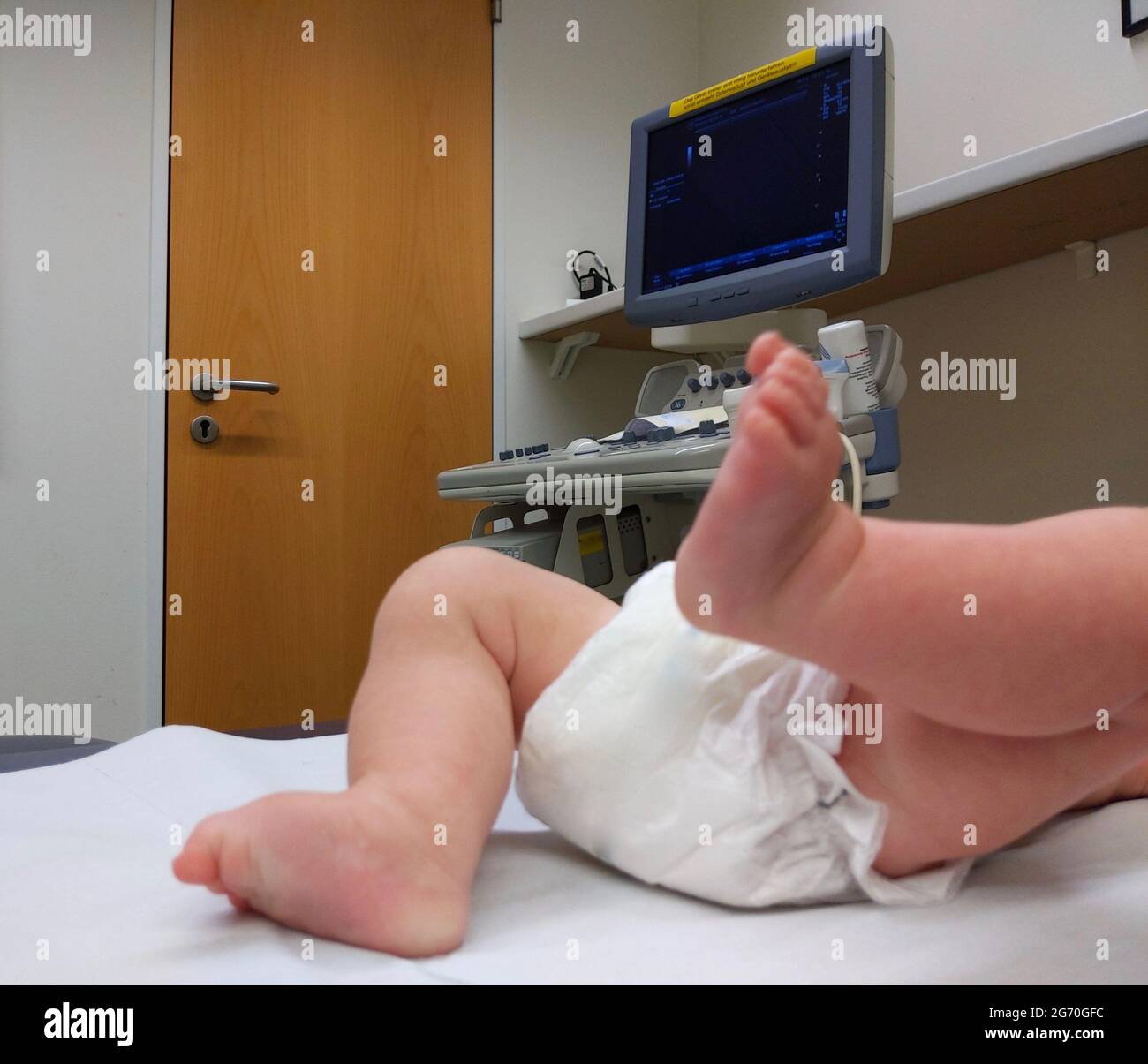 Baby in doctors examination room with ultrasound scanner in the ...