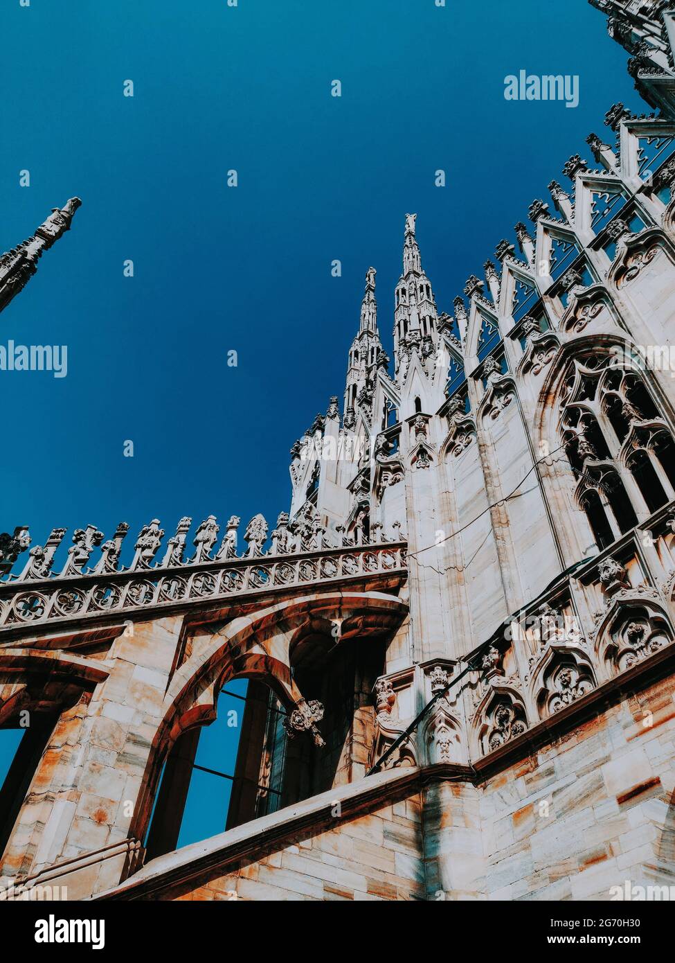 Low angle shot of Milan Cathedral (Duomo di Milano) against a clear ...