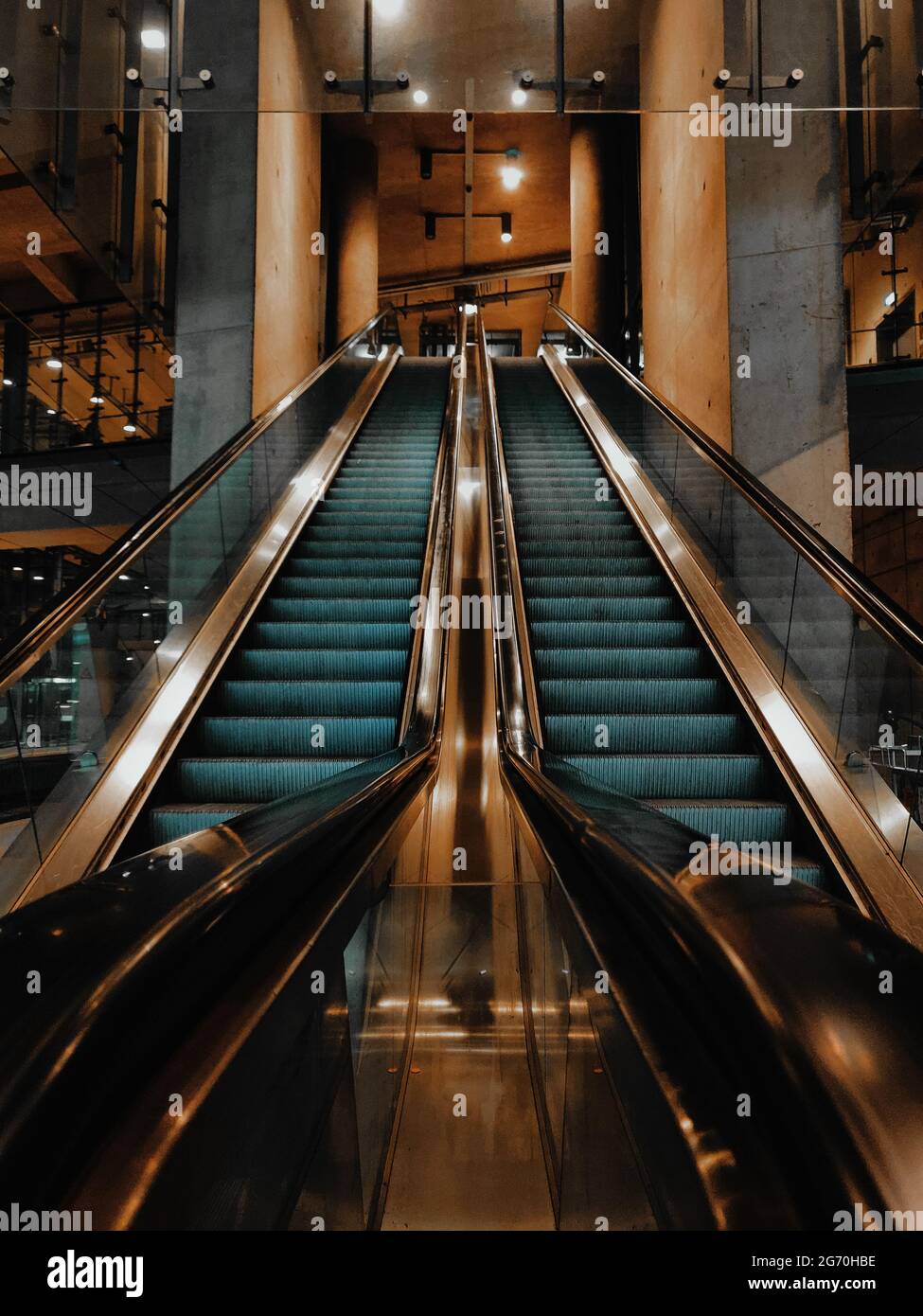 Modern escalator inside a building Stock Photo - Alamy