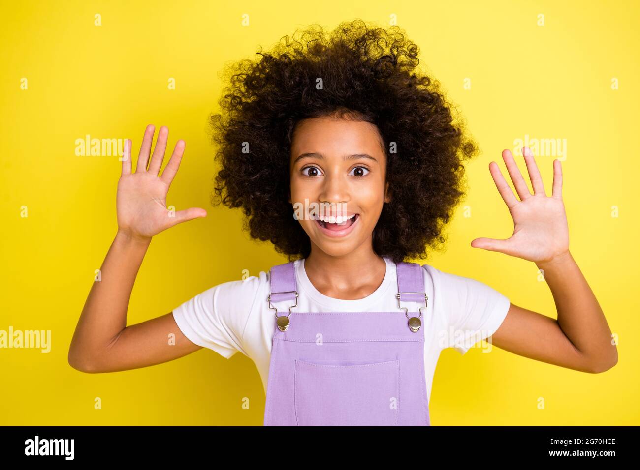Portrait of nice cheerful wavy-haired girl showing give double five ...
