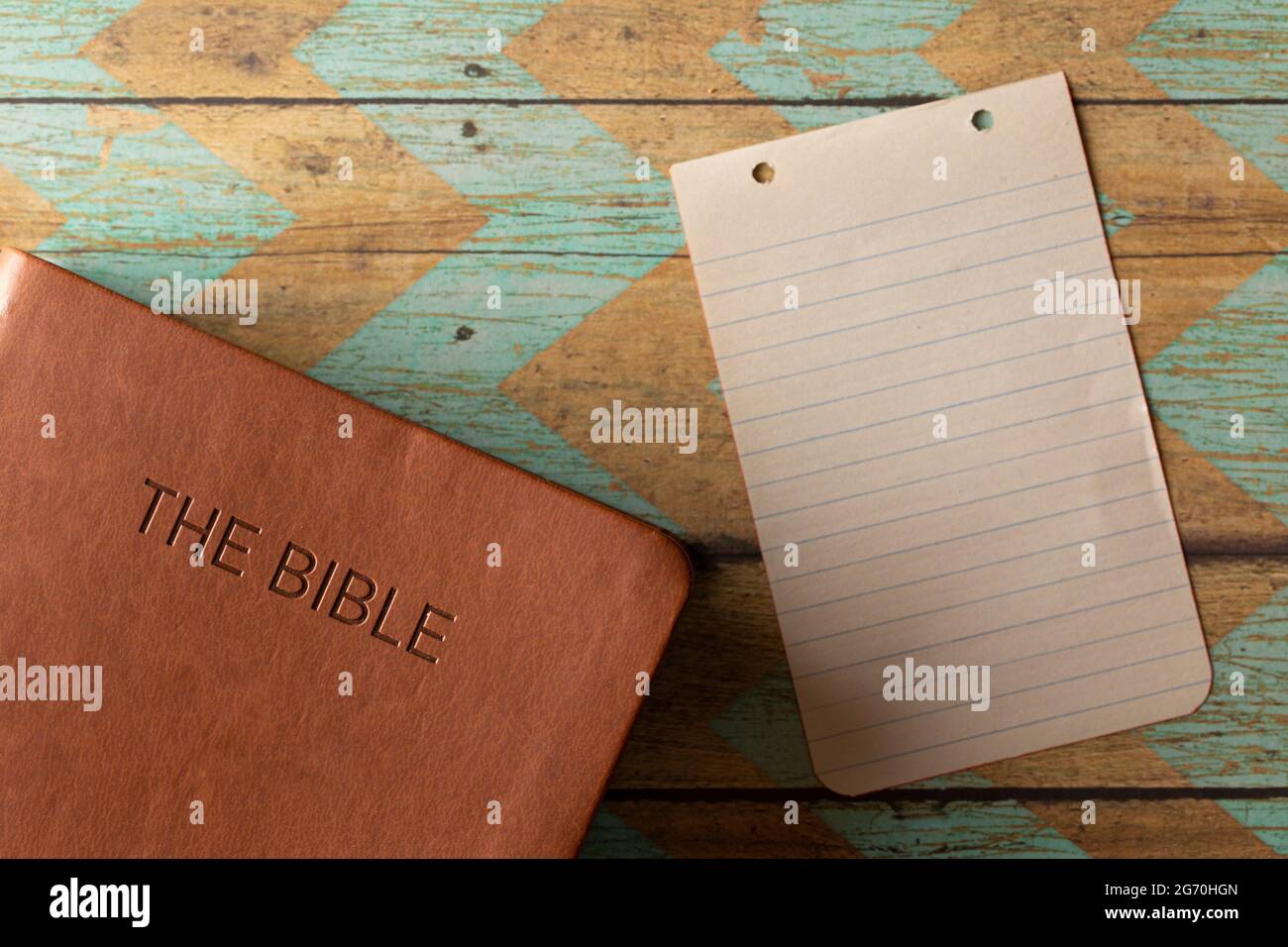 The Holy Bible on a Rustic Wooden Table with a Blank Piece of Antique ...