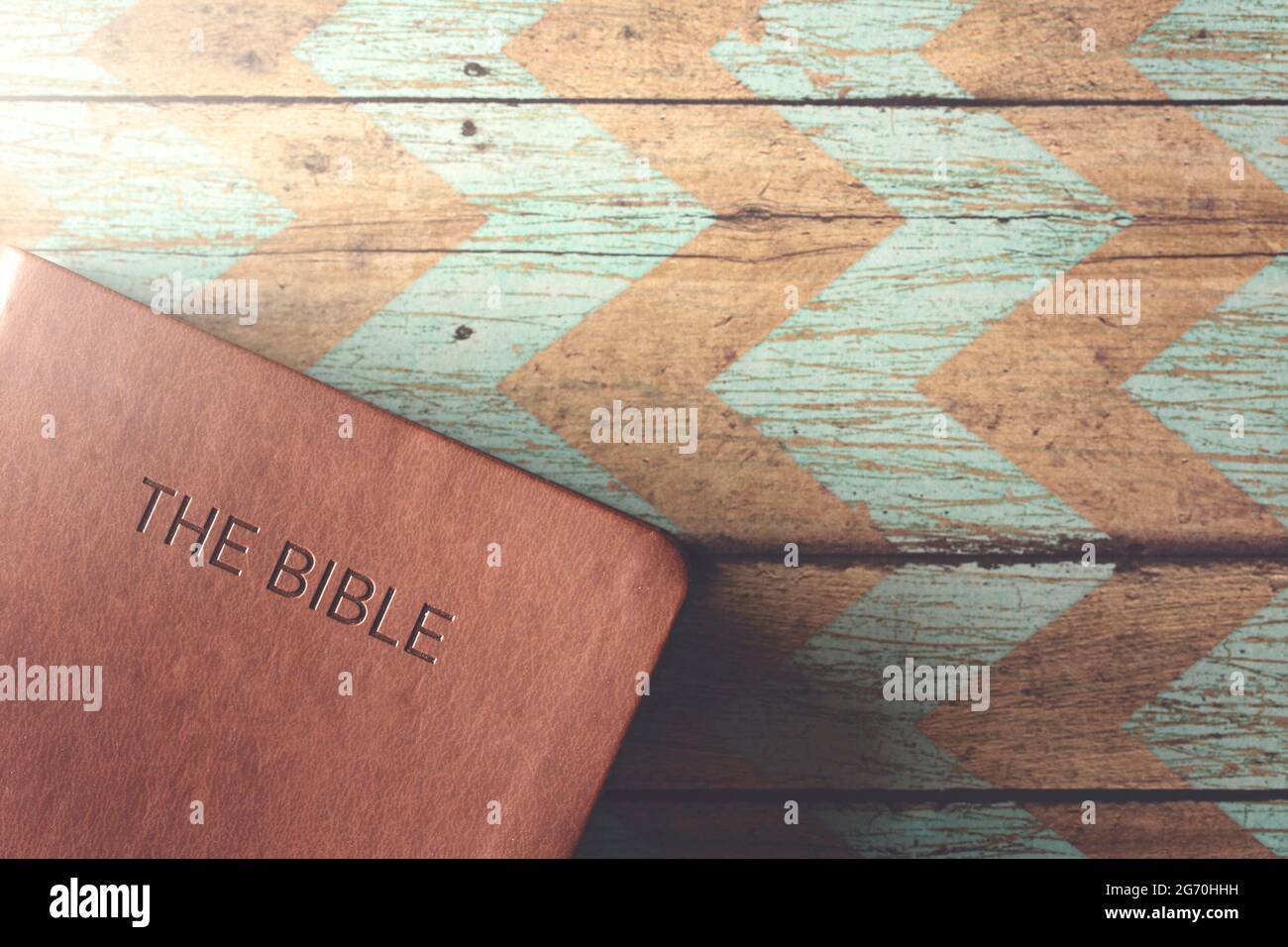 The Holy Bible on a Rustic Wooden Table with a Blank Piece of Antique ...