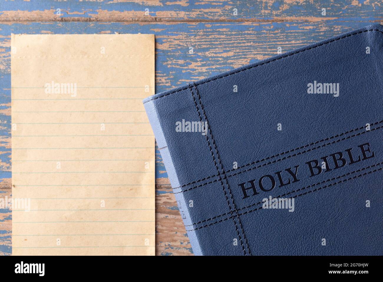 The Holy Bible on a Rustic Wooden Table with a Blank Piece of Antique ...