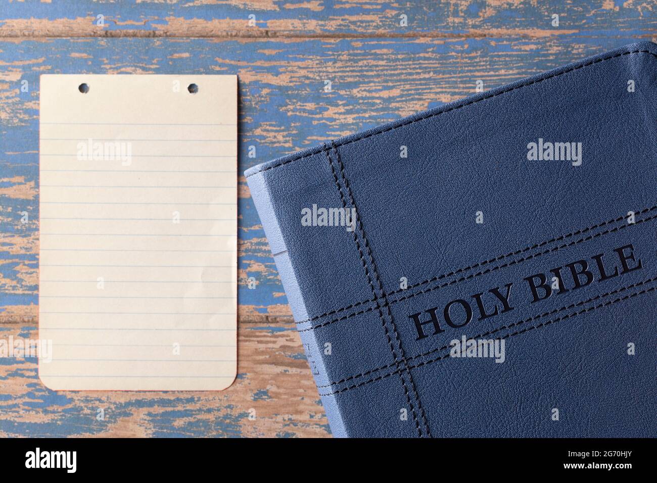 The Holy Bible on a Rustic Wooden Table with a Blank Piece of Antique ...