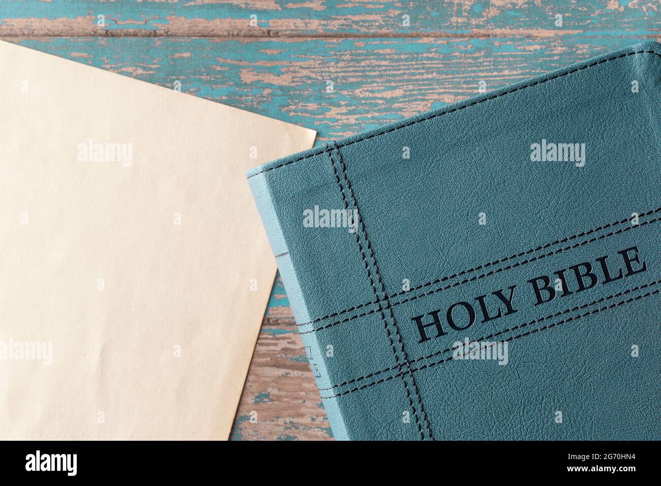 The Holy Bible on a Rustic Wooden Table with a Blank Piece of Antique ...