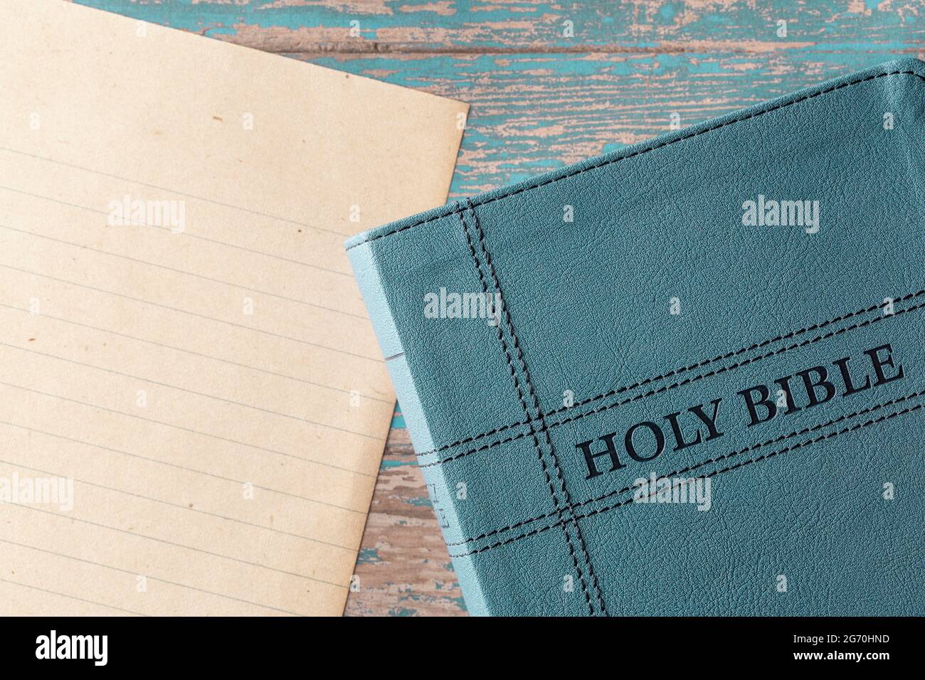 The Holy Bible on a Rustic Wooden Table with a Blank Piece of Antique ...