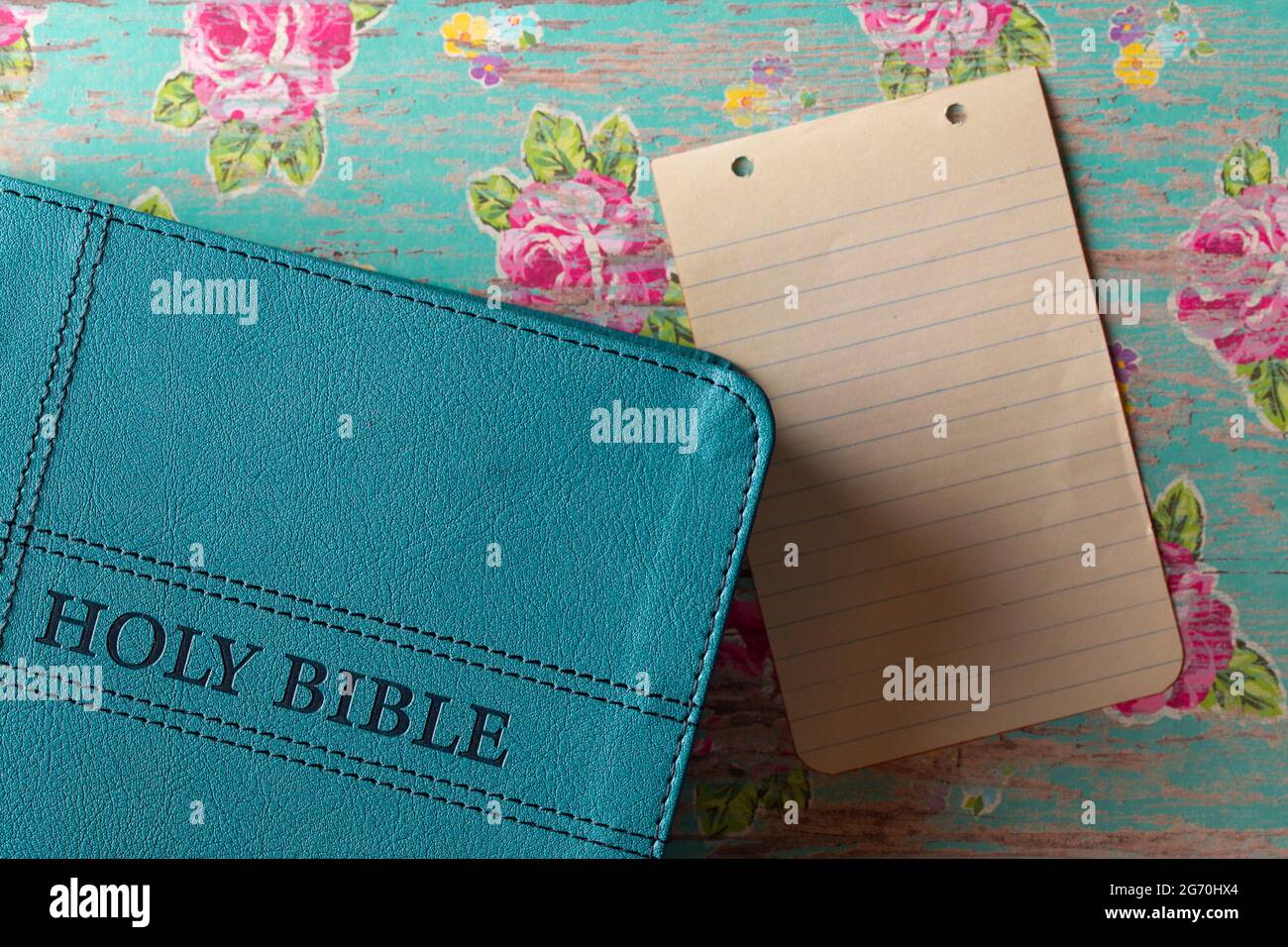 The Holy Bible on a Rustic Wooden Table with a Blank Piece of Antique ...
