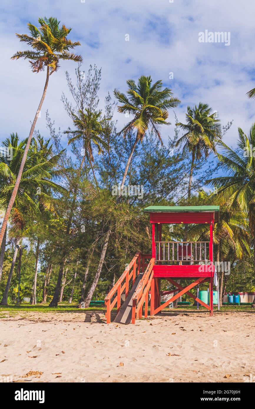 Red Life guard hut and palm trees on tropical beach. Luquillo Beach ...