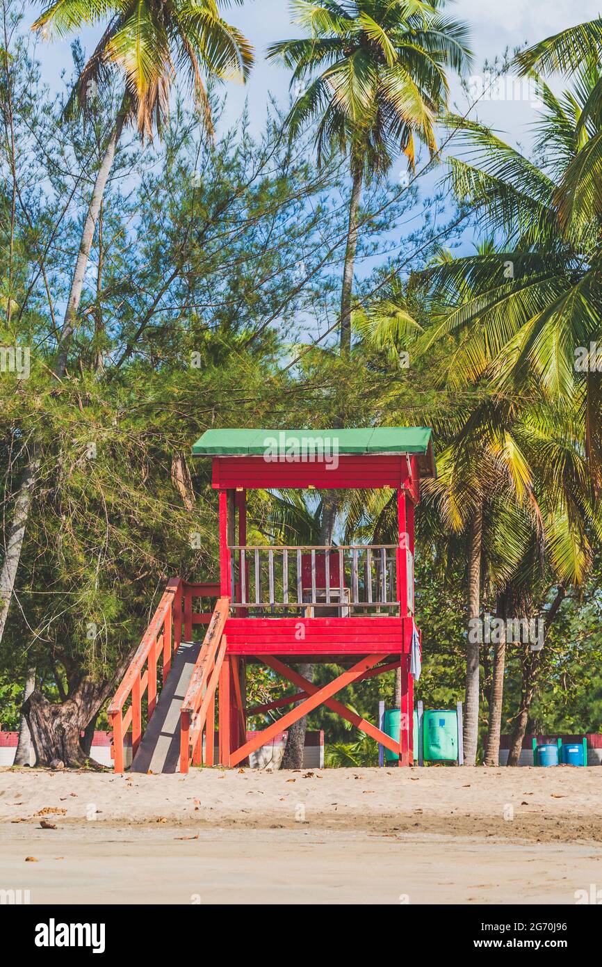 Red Life guard hut and palm trees on tropical beach. Luquillo Beach ...