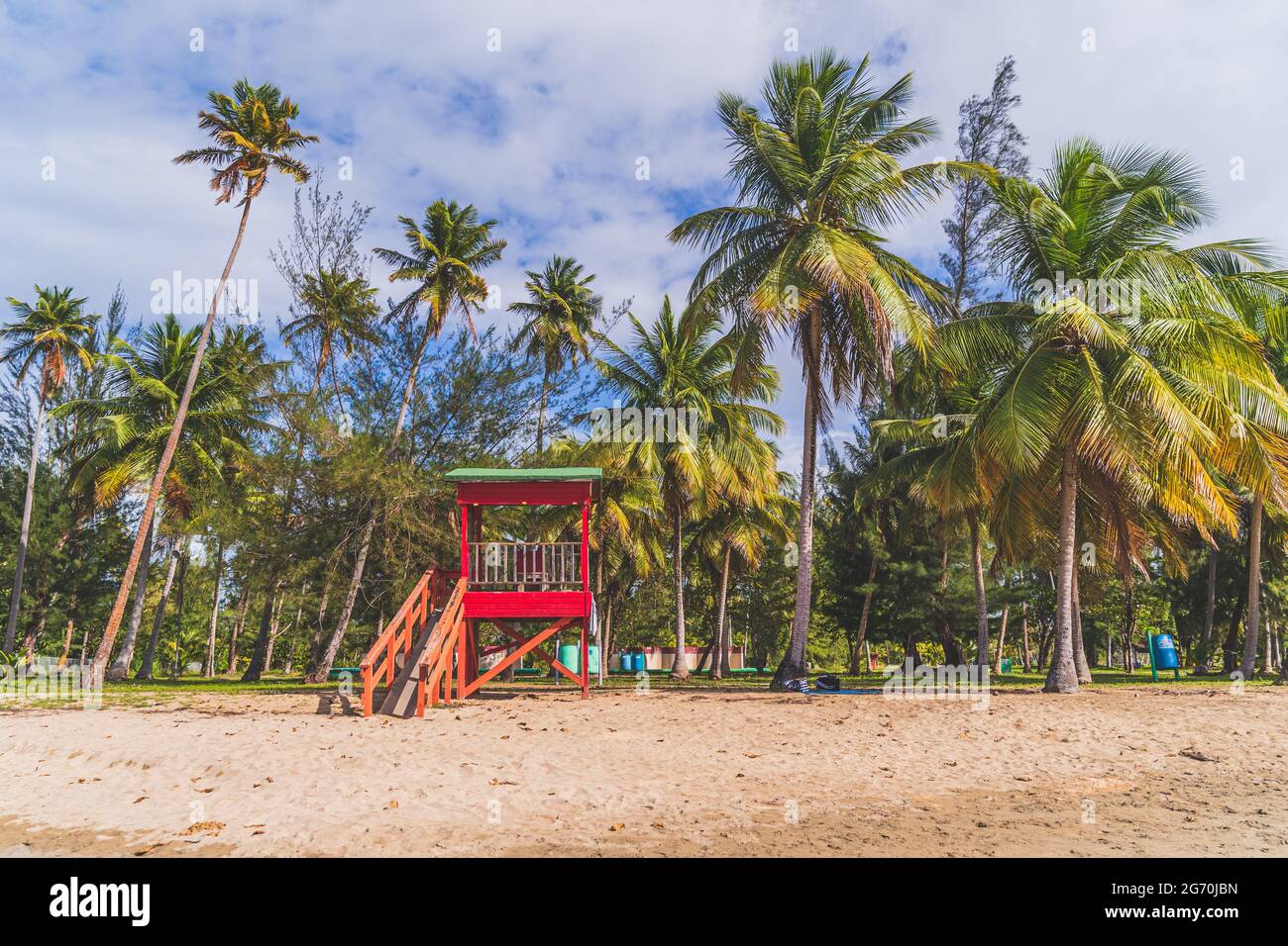 Red Life guard hut and palm trees on tropical beach. Luquillo Beach ...