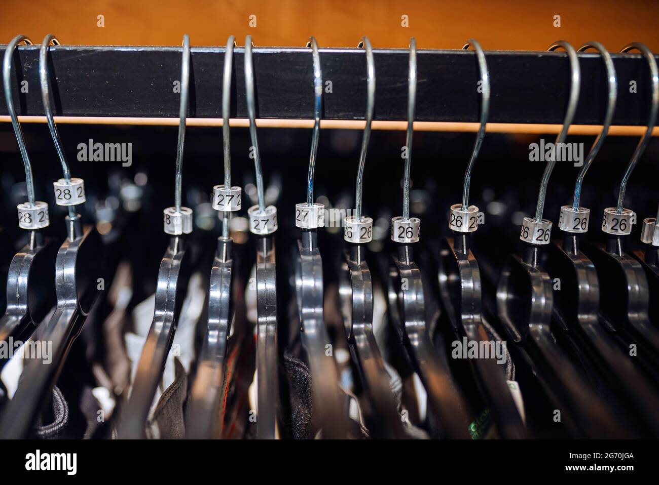 Stylish clothes on a hanger in a store. New collection of coats Stock ...