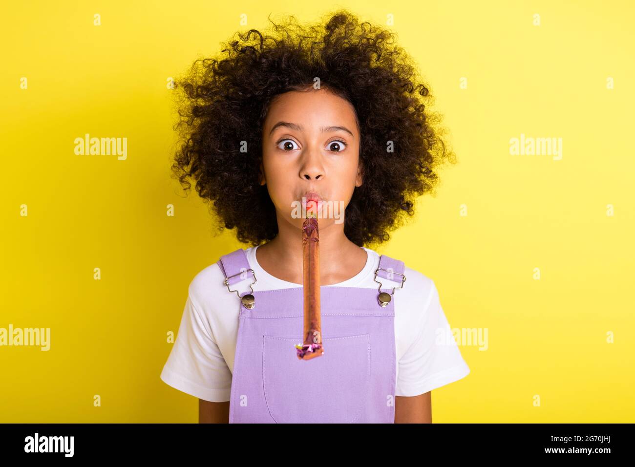 Portrait of pretty funky childish wavy-haired girl blowing whistle ...