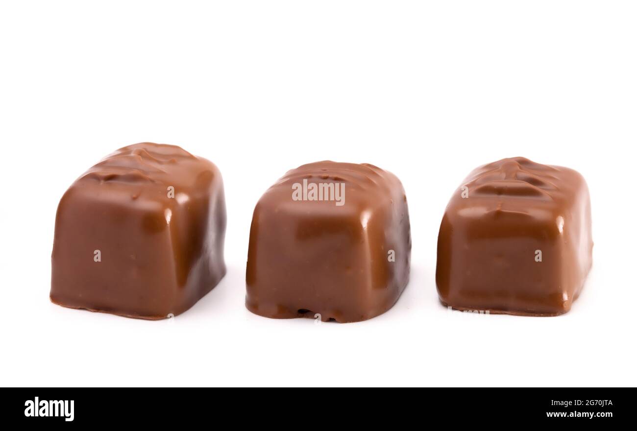Three Milk Chocolate Truffles in a Row Isolated on a White Background ...