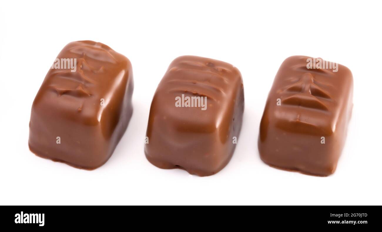 Three Milk Chocolate Truffles in a Row Isolated on a White Background ...