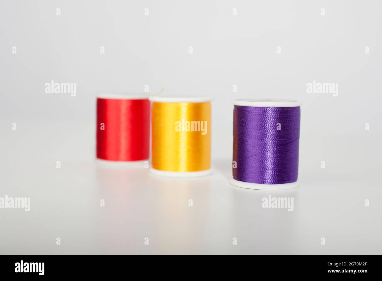 colorful thread on a white background Stock Photo - Alamy