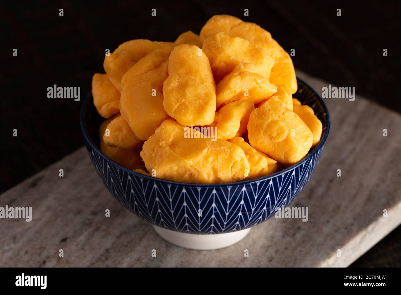 A Bowl of Cheddar Cheese Curds on a Rustic Wooden Table Stock Photo - Alamy