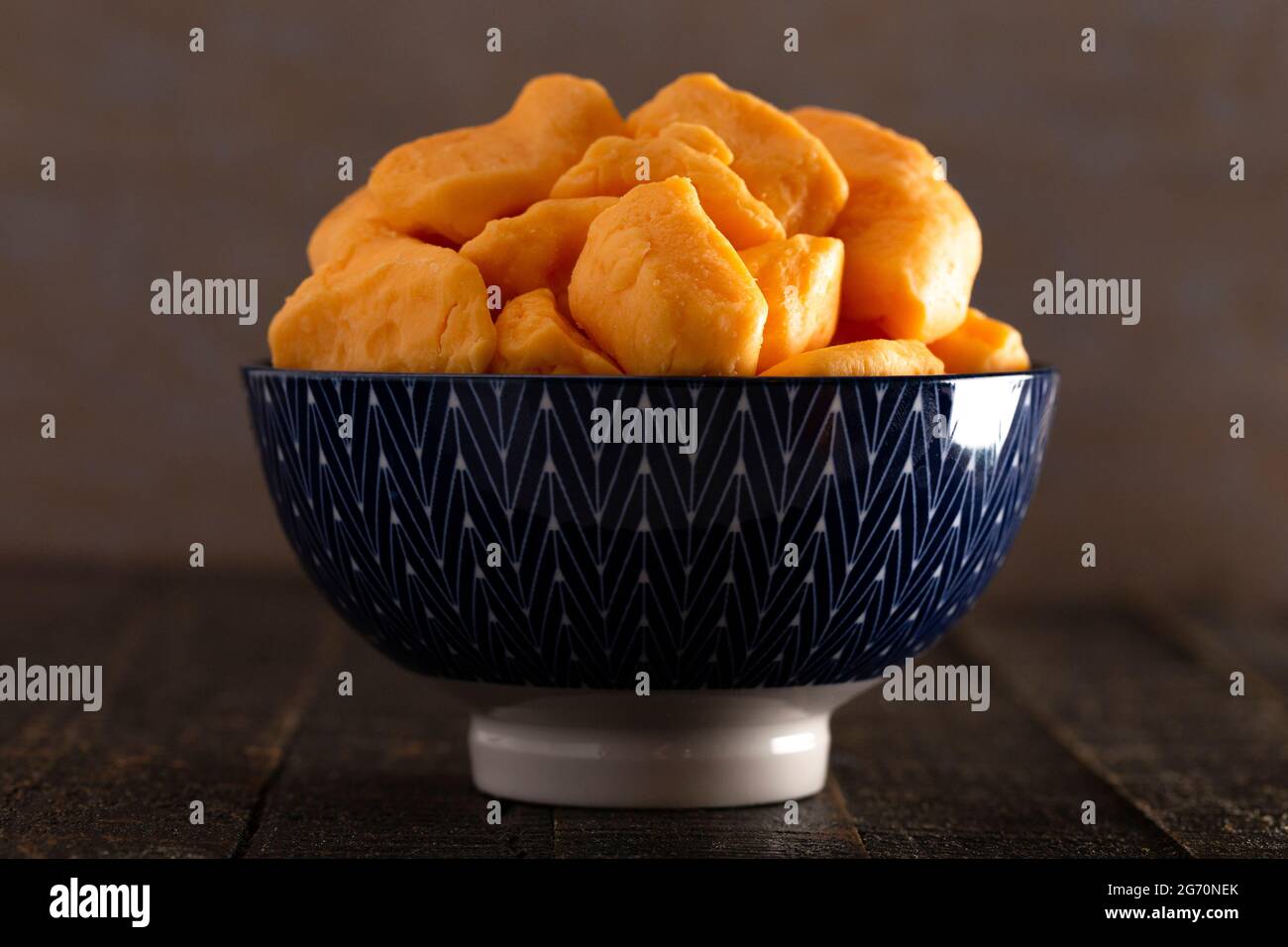 A Bowl of Cheddar Cheese Curds on a Rustic Wooden Table Stock Photo - Alamy