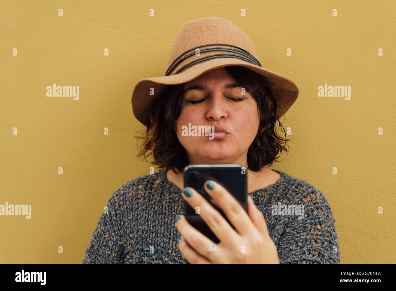 Woman sends a kiss to her boyfriend in a video call Stock Photo - Alamy
