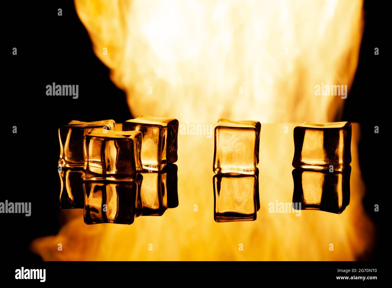ice cubes on a black background in flames Stock Photo - Alamy
