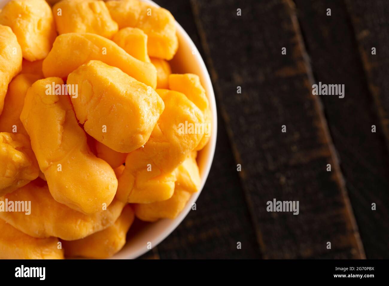 A Bowl of Cheddar Cheese Curds on a Rustic Wooden Table Stock Photo - Alamy