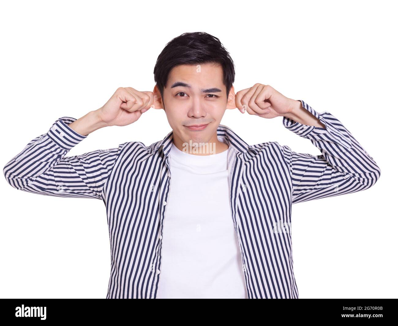 young man holding his ears and playful grimace expression Stock Photo ...