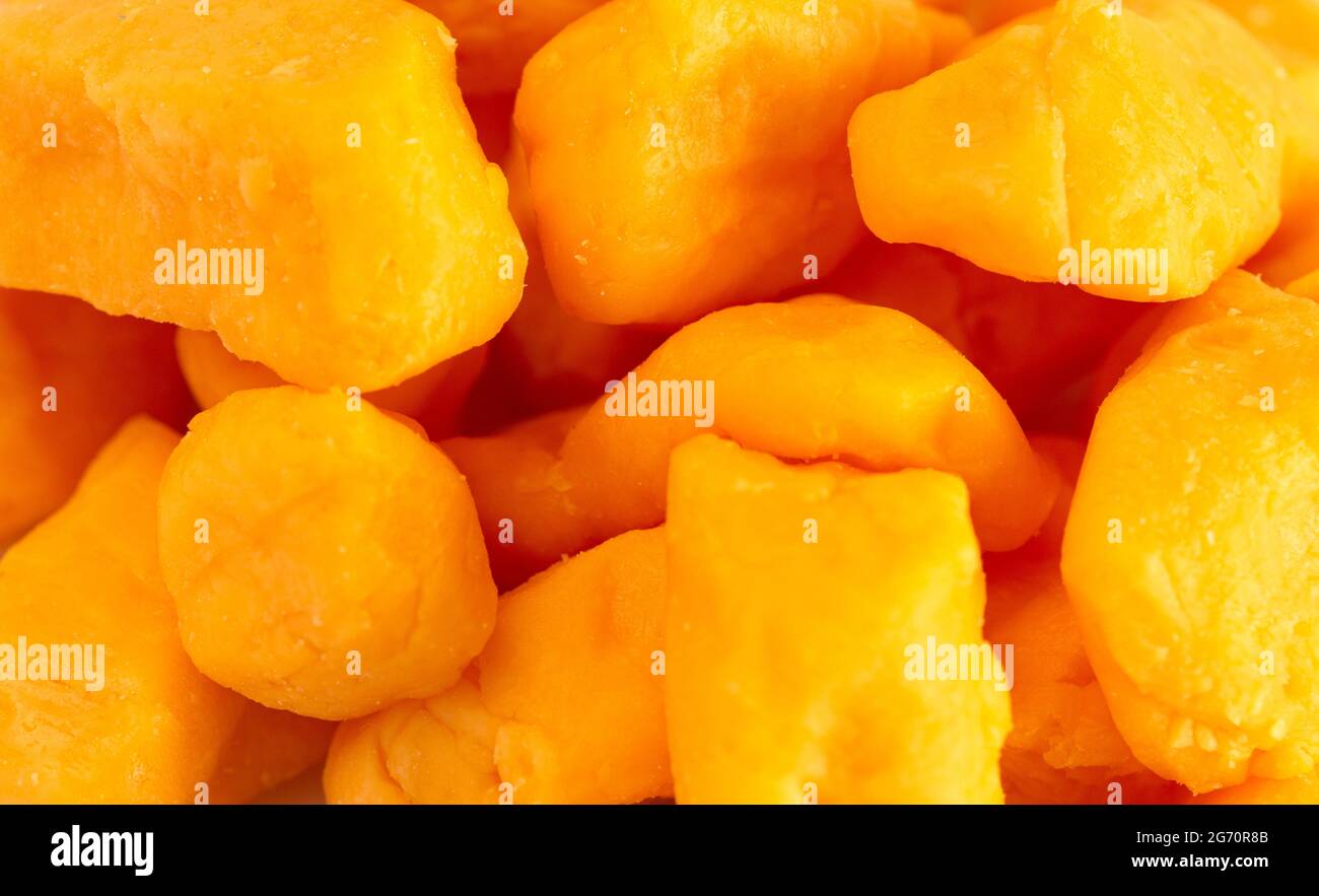 An Upclose Background Cheddar Cheese Curds Stock Photo - Alamy