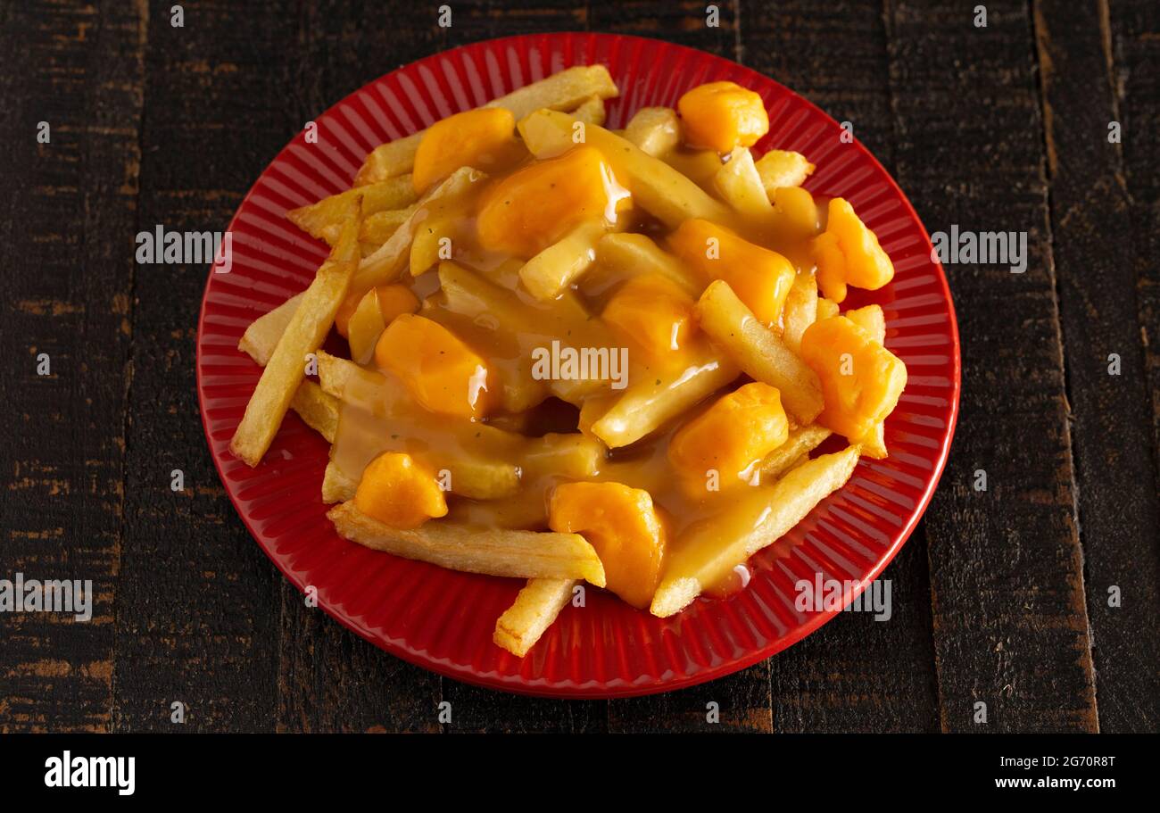 Poutine with Orange Cheddar Cheese with Brown Gravy on French Fries ...