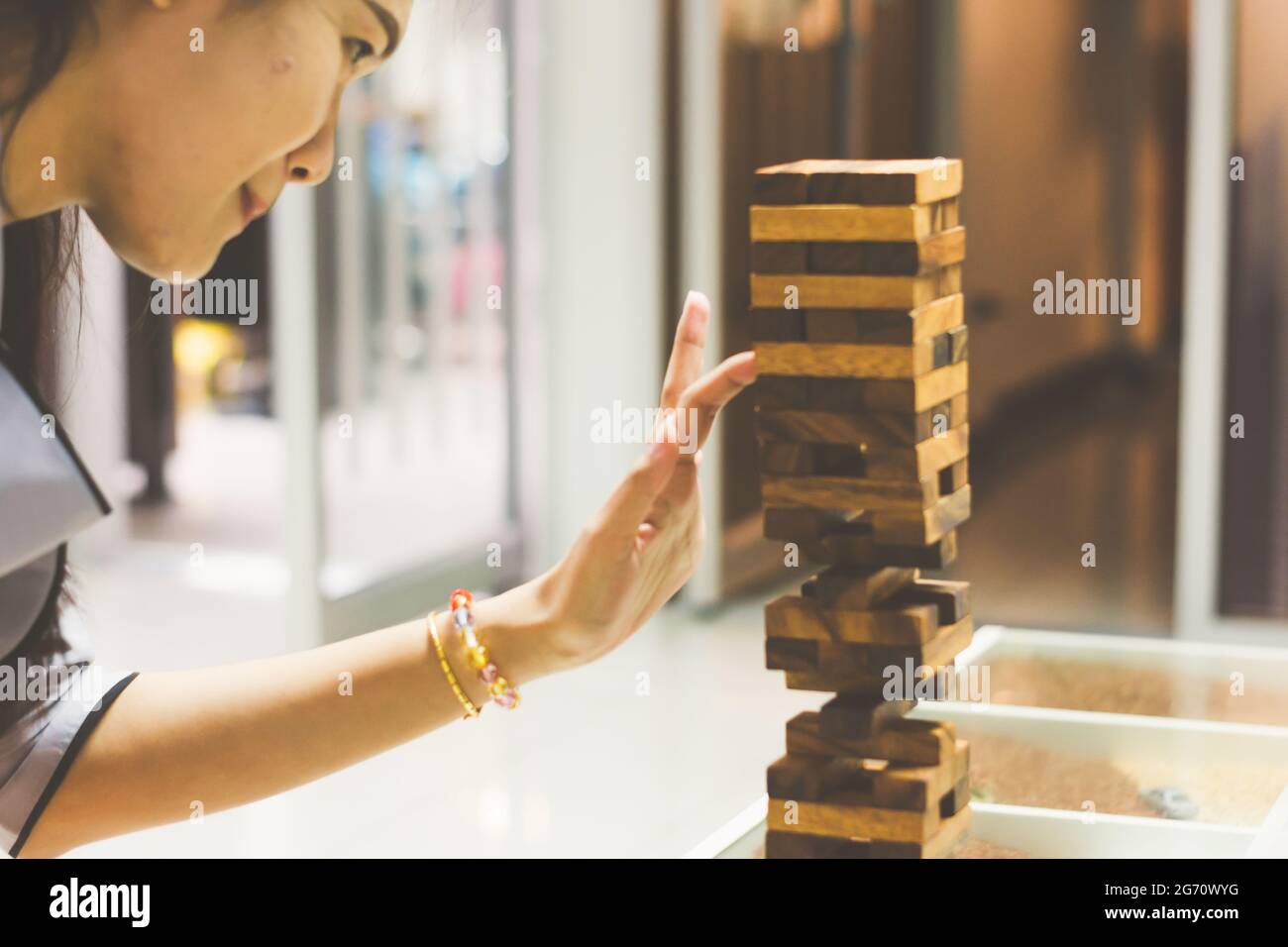Close up woman playing jenga block. For business success concept Stock ...