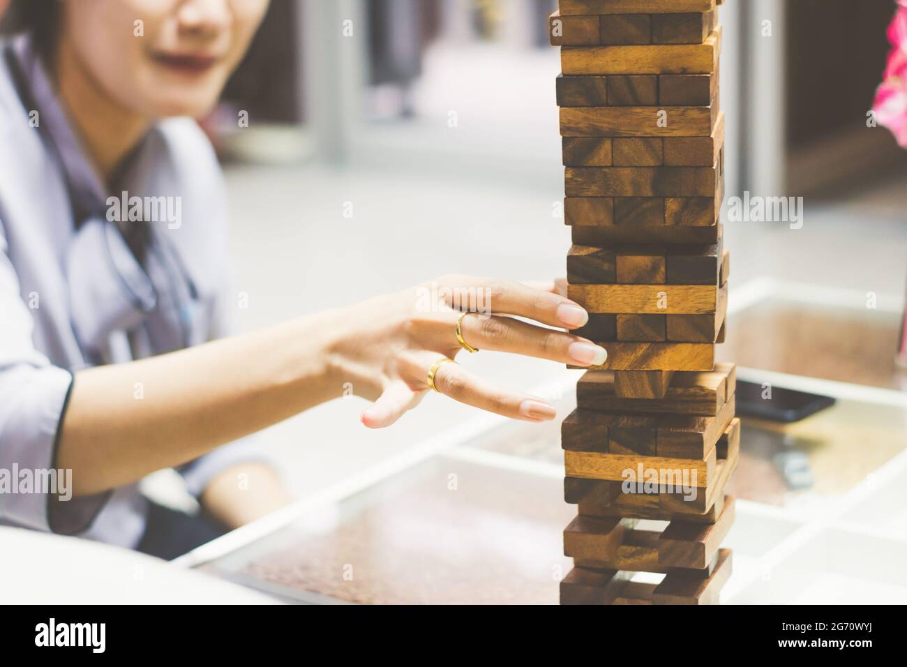 Close up woman playing jenga block. For business success concept Stock ...