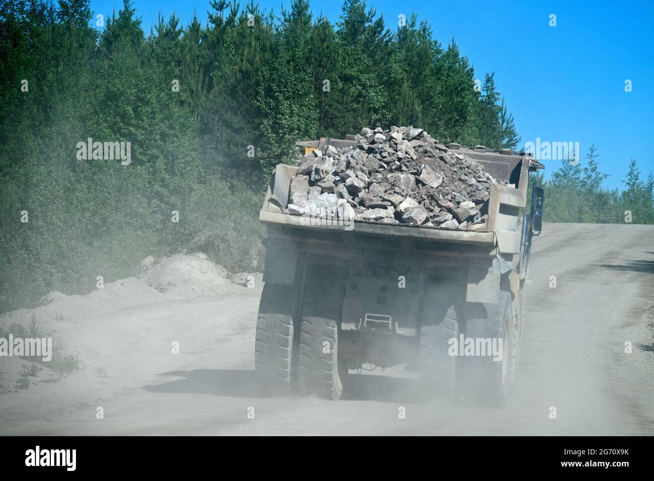 Open-pit operation. Pit dump truck, large-capacity dump truck rides on ...