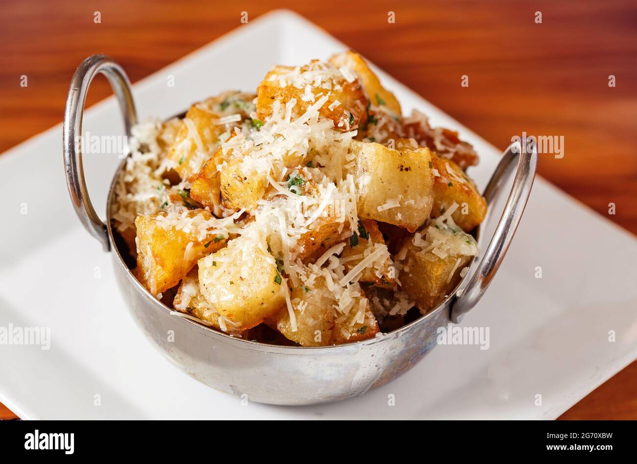 Italian style duck fat potatoes in a silver serving pot Stock Photo - Alamy