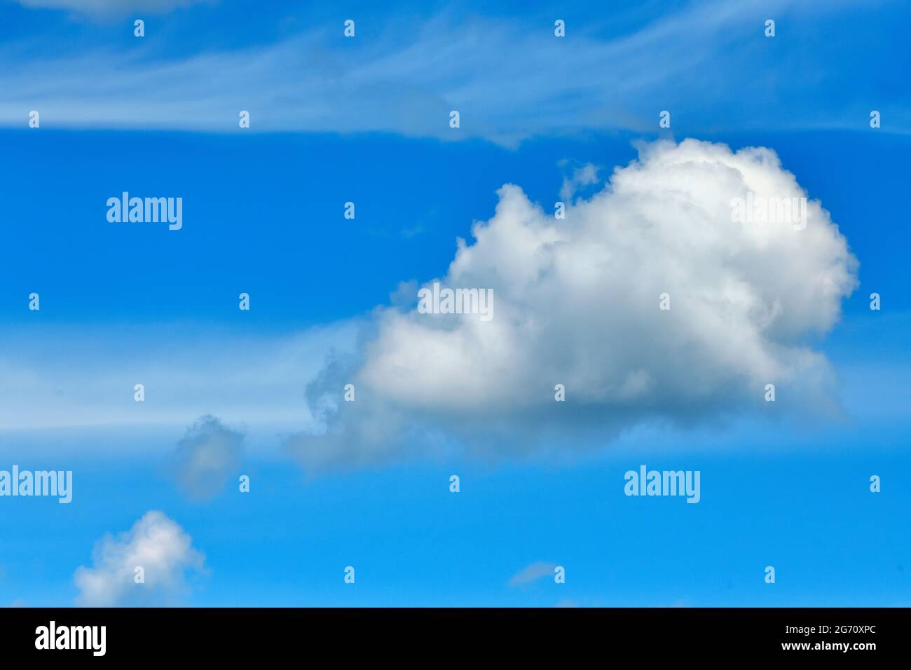 A fluffy white cloud floating in a blue sky in Alberta Canada Stock ...