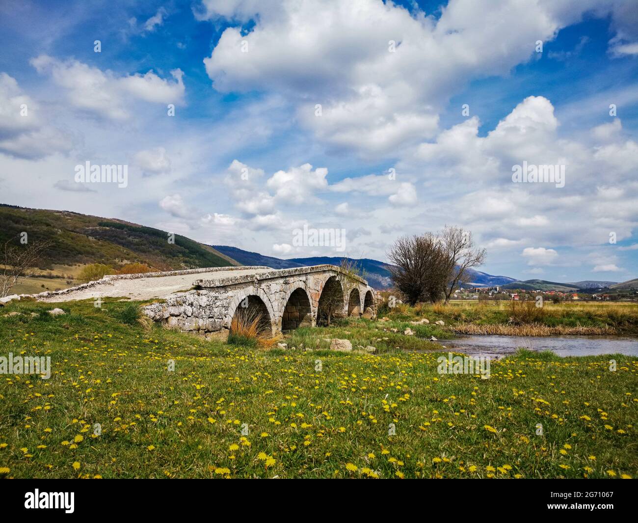 Beautiful view of a landscape with an old concrete bridge under a ...