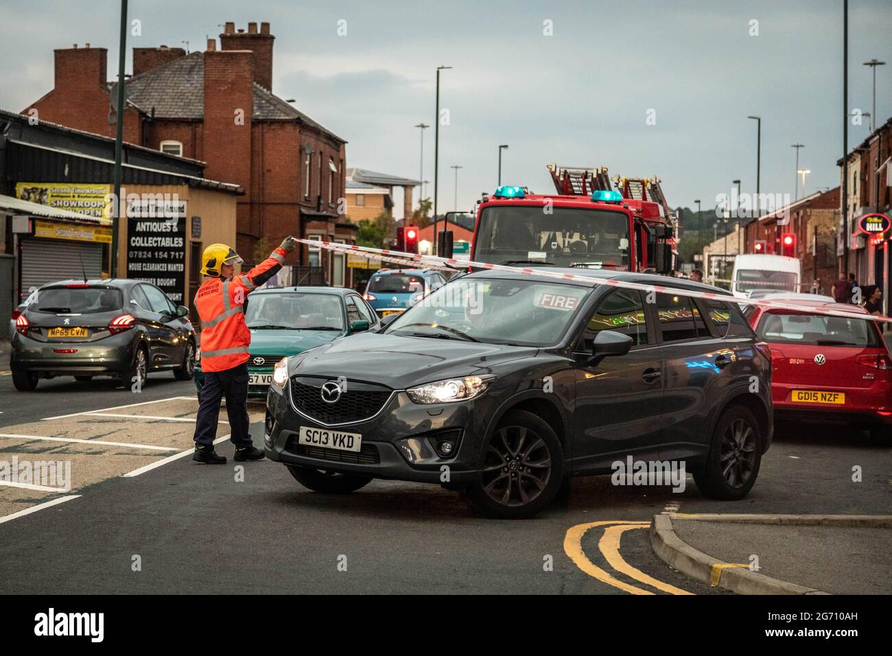 Manchester, UK. 09th July, 2021. A man lifts the tape as the fire ...
