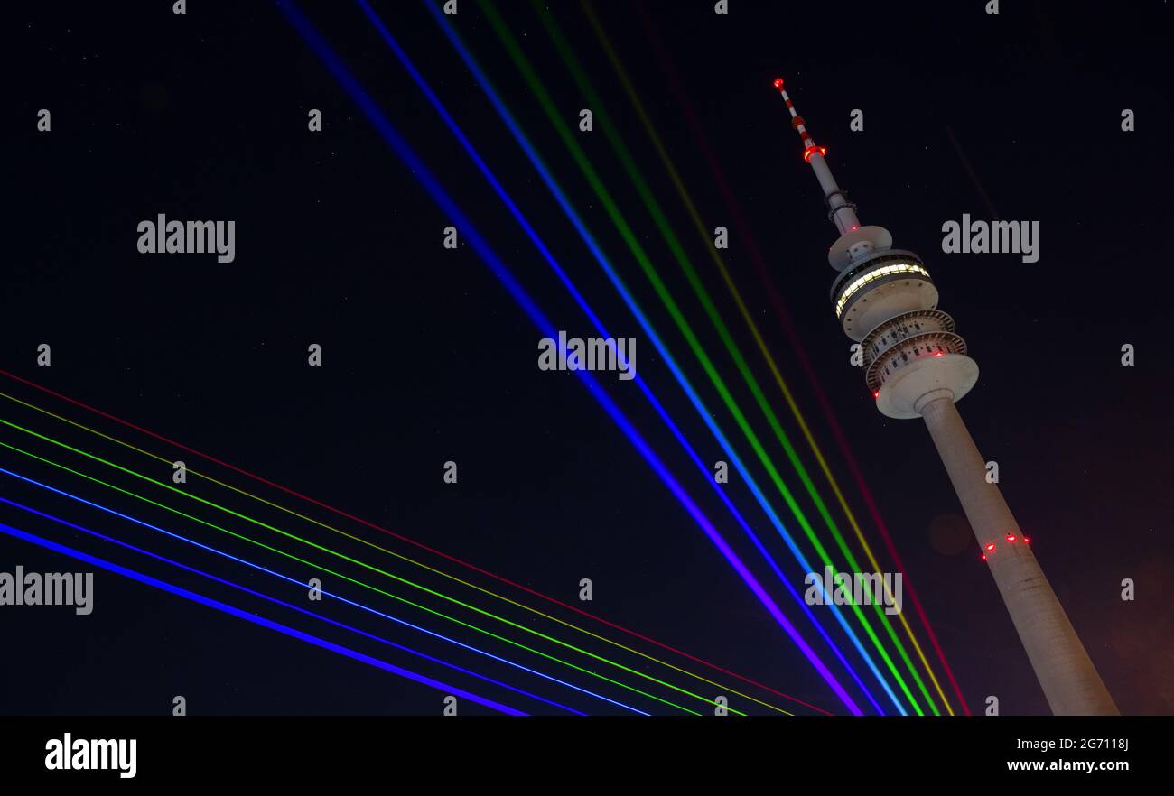 Munich, Germany. 10th July, 2021. Laser beams project colorful rays ...