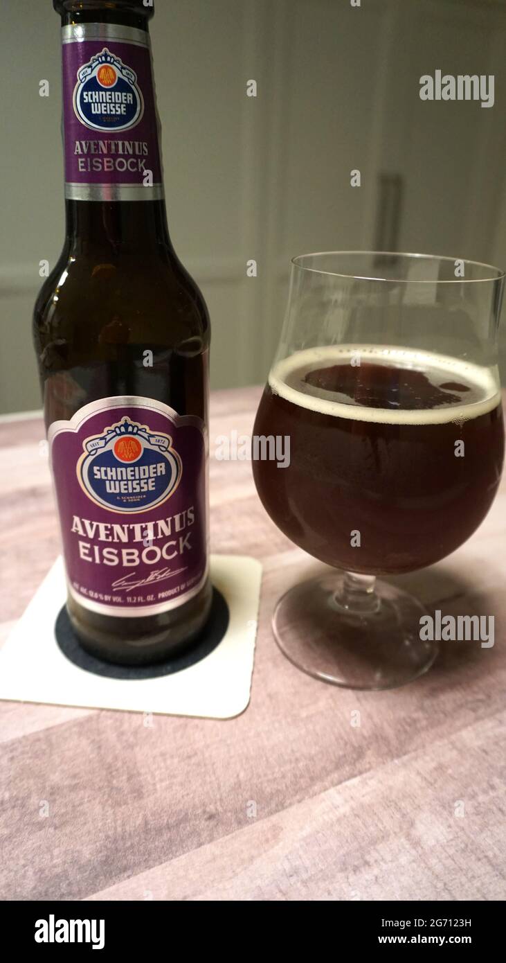 Bottle of Schneider Weisse Aventinus Eisbock beer poured into a serving ...