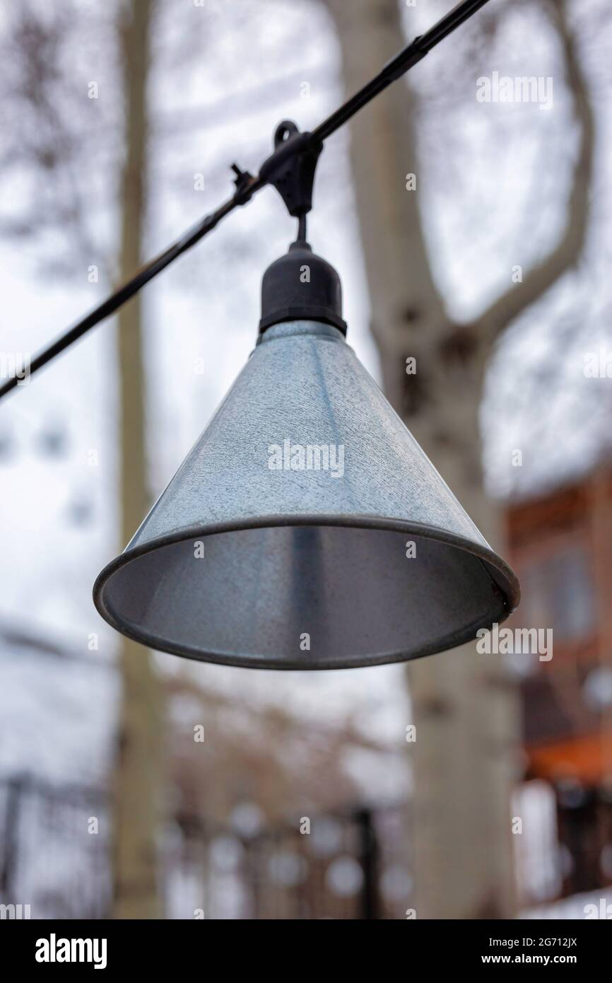 Vertical shot of a lamp hanging on a rope outdoor Stock Photo - Alamy