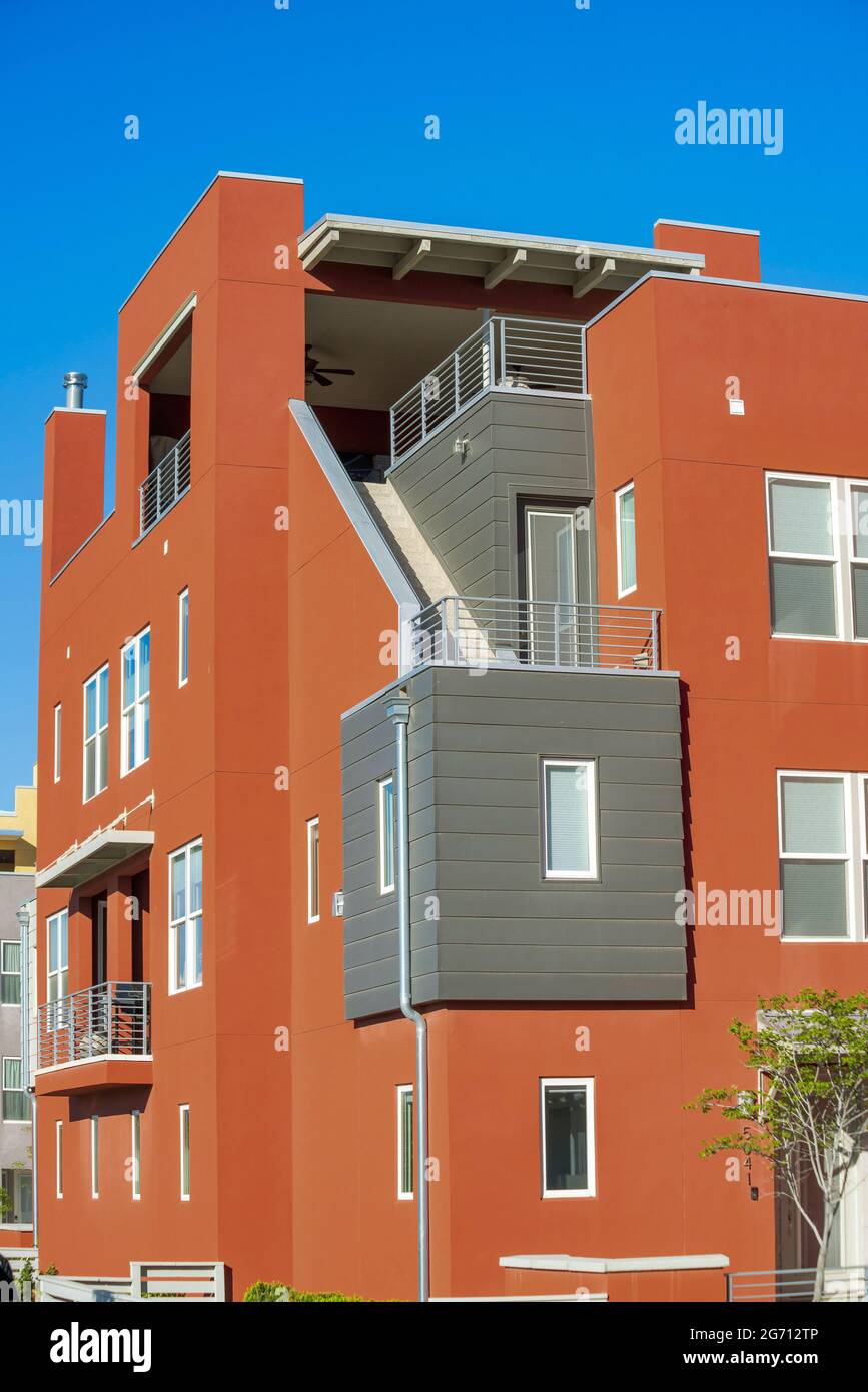 Modern brown three story brick building on the street with clear sky in ...