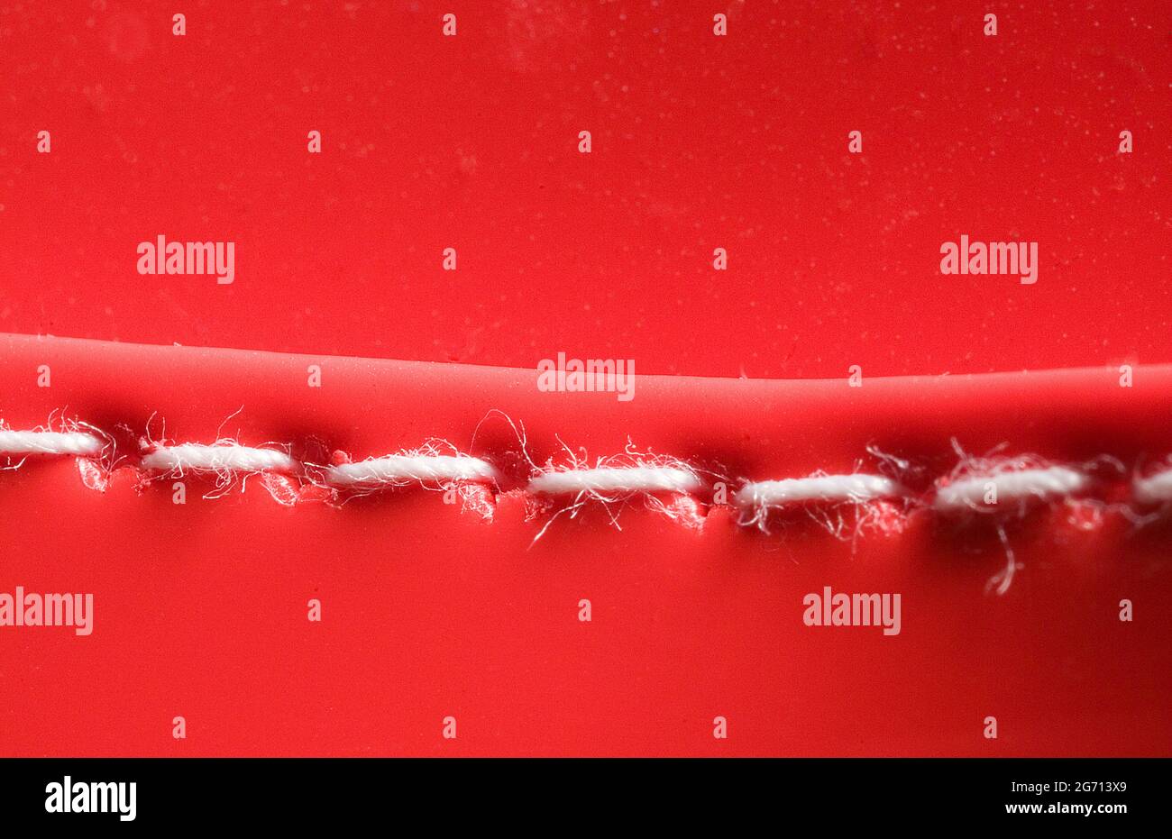 White stitching on red bag detail Stock Photo - Alamy
