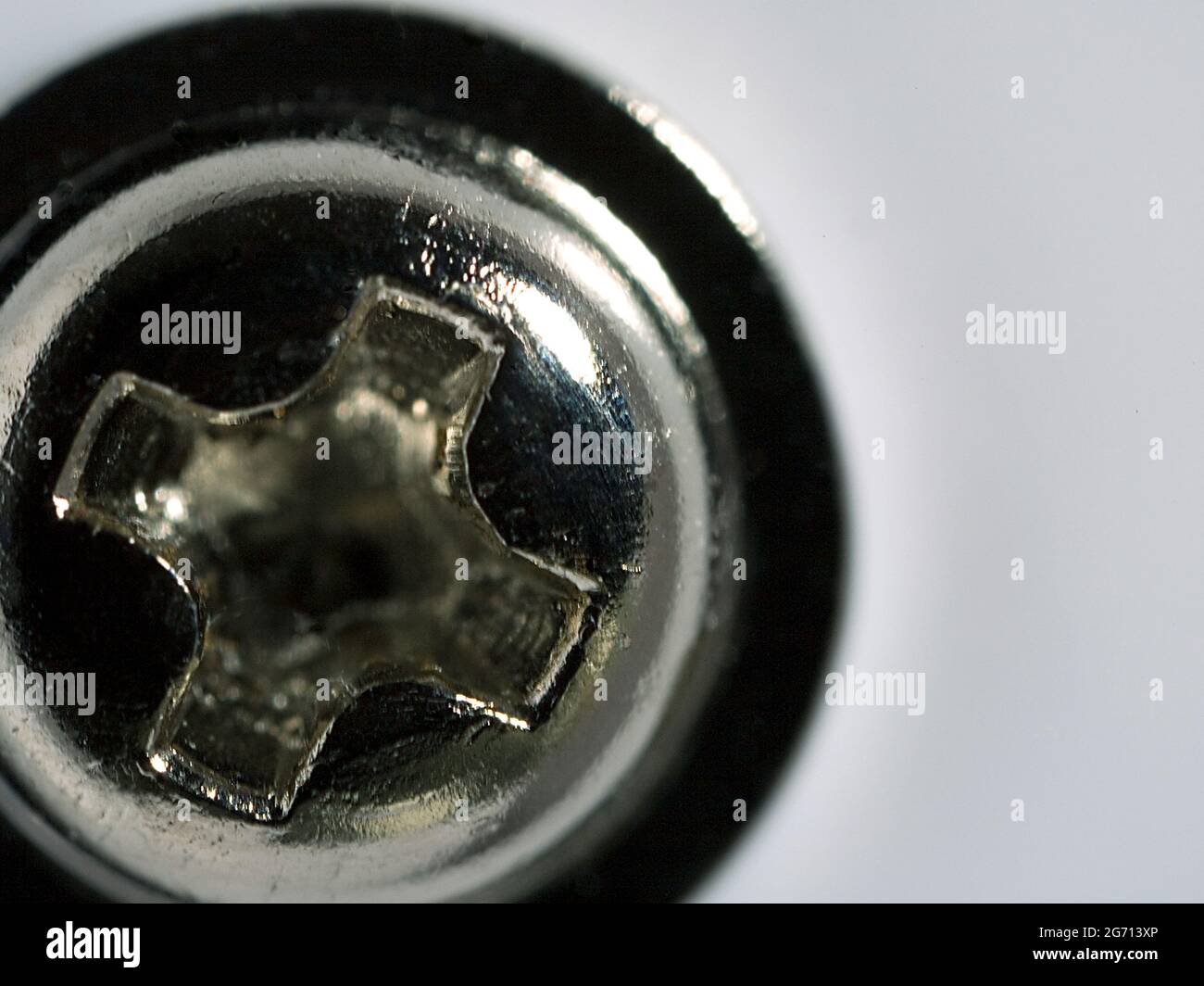 Phillips head screw head close up Stock Photo - Alamy