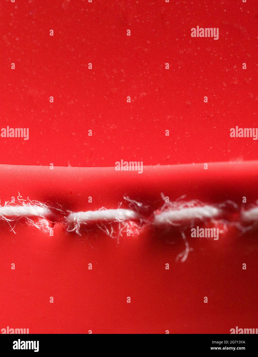 White stitching on red bag detail Stock Photo - Alamy