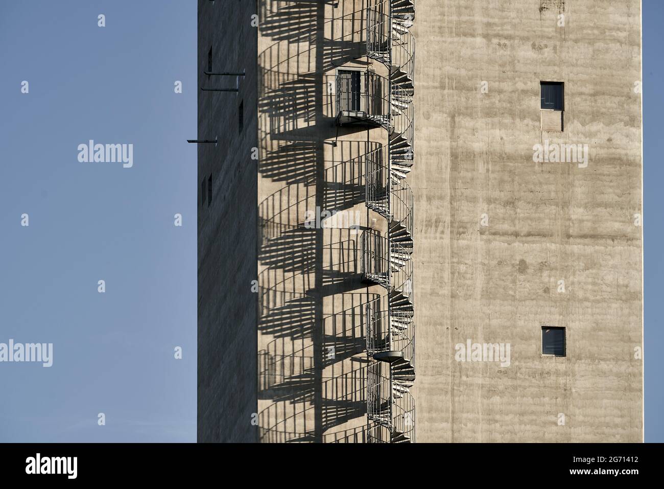 Beautiful shot of a spiral emergency fire exit stairs on the back of a ...