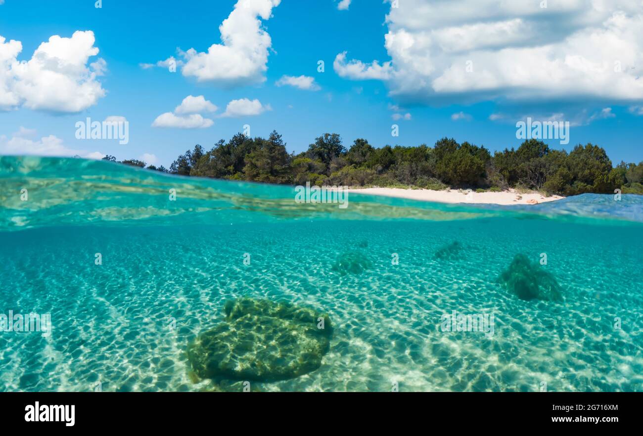 Split-shot, over-under shot. Half underwater half sky with a turquoise ...