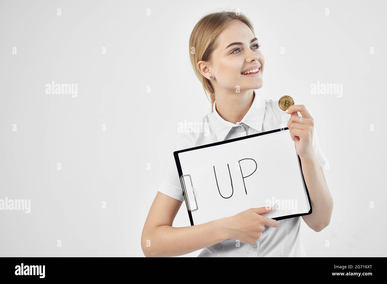 woman in white shirt coin cryptocurrency raising Stock Photo - Alamy
